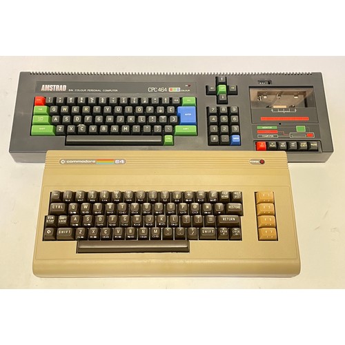 A Commodore C64 computer, together with a Amstrad CPC 464 computer. (2)