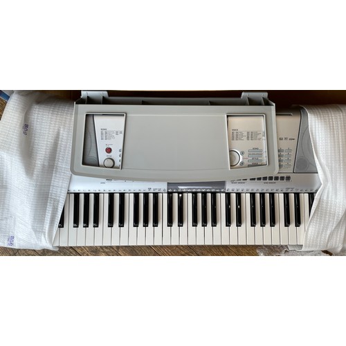 A Yamaha electronic keyboard, model PSR-295, boxed.
