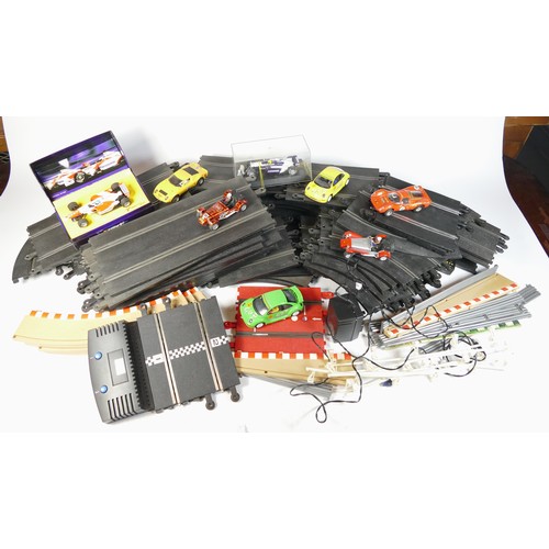 A collection of Scalextric model racing parts, track, and cars.