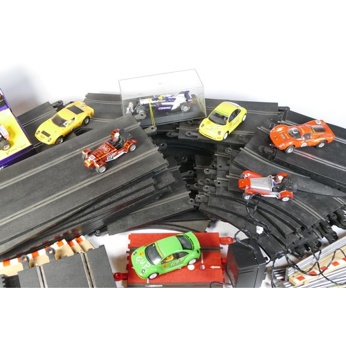 A collection of Scalextric model racing parts, track, and cars.