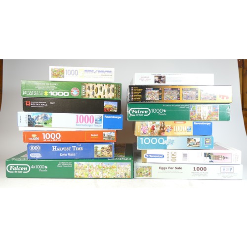 A collection of jigsaw puzzles (boxed) with a jigsaw fold board.