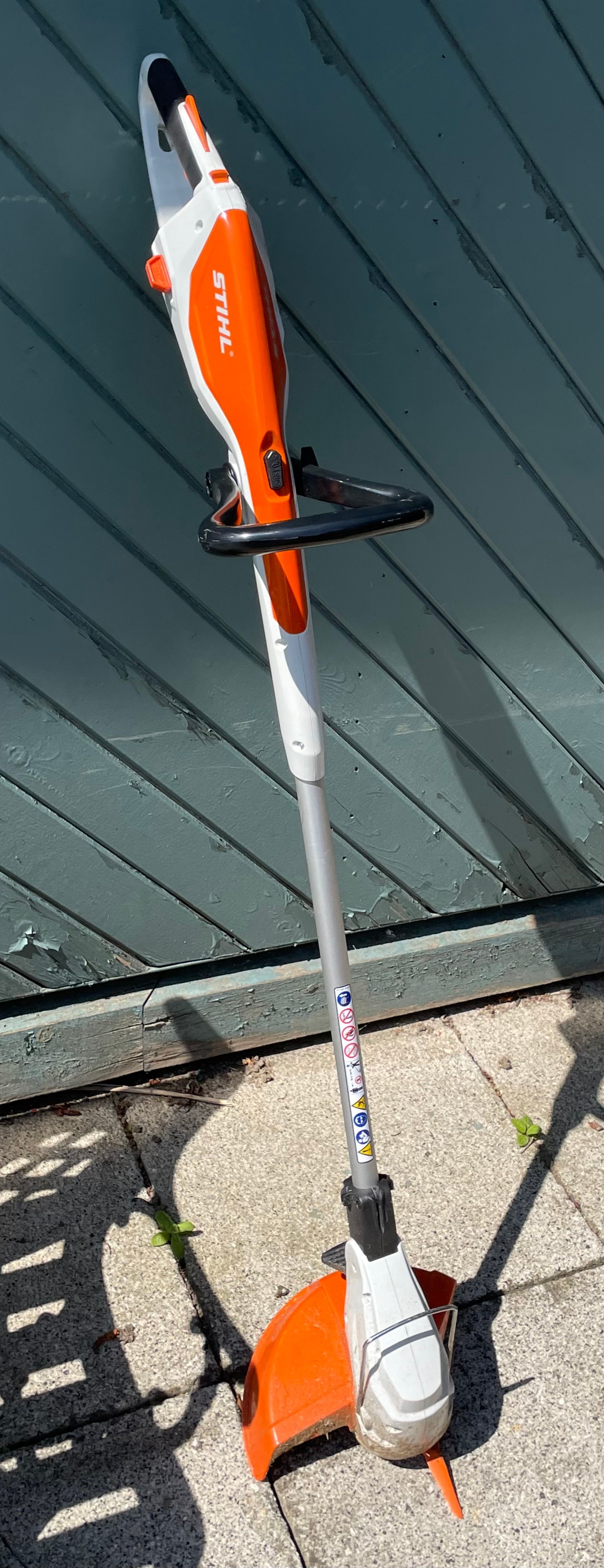 A Stihl cordless strimmer, model FSA45, lacking charger lead
