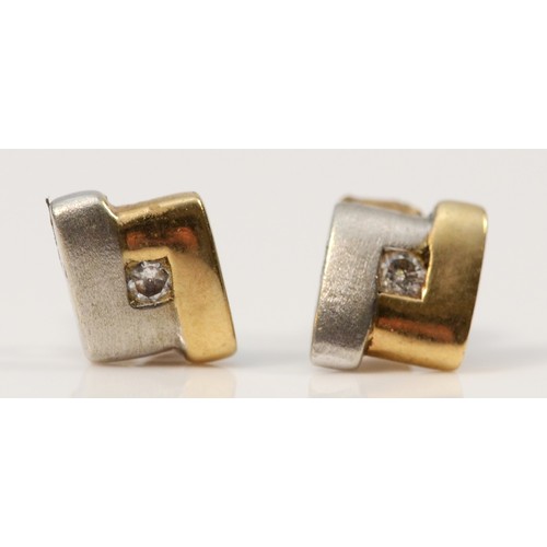 A pair of 9ct white and yellow gold diamond stud earrings with scroll ...