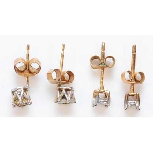 Two pairs of 9ct gold diamond single stone stud earrings, 1g