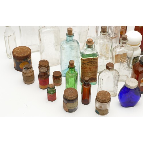 A collection of glass pharmacy bottles and measures, including Poison ...