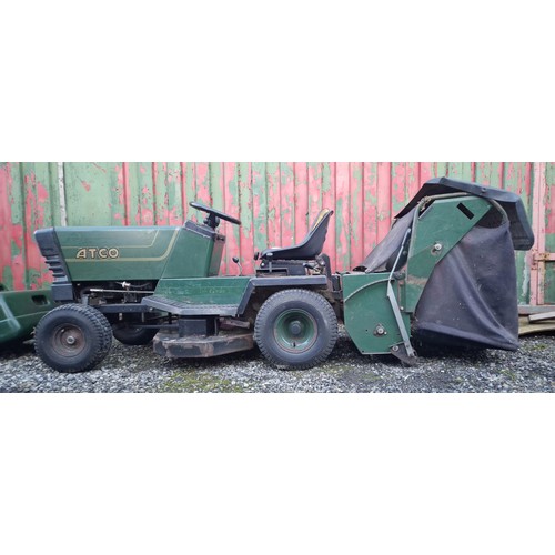 An Atco ride-on tractor with powered lawn sweeper, model 12/36, series ...