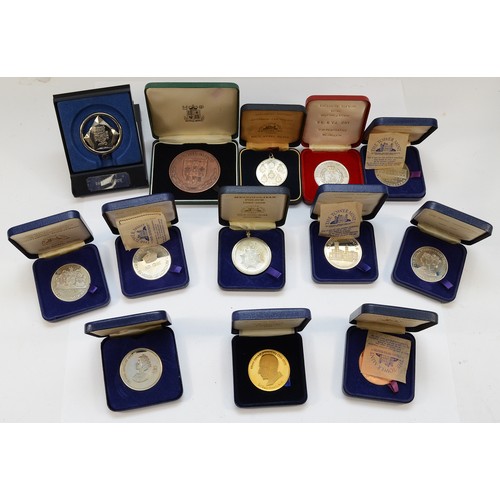 A collection of thirteen commerative medallions and awards, to include ...