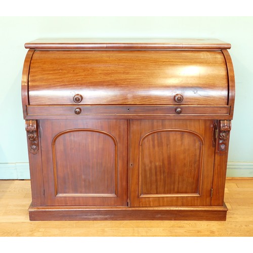 A Victorian mahogany cylinder writing desk, the roll top enclosing ...