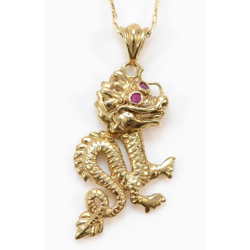 A 9ct gold ruby eyed dragon pendant with a chain, 25mm, 2.5g