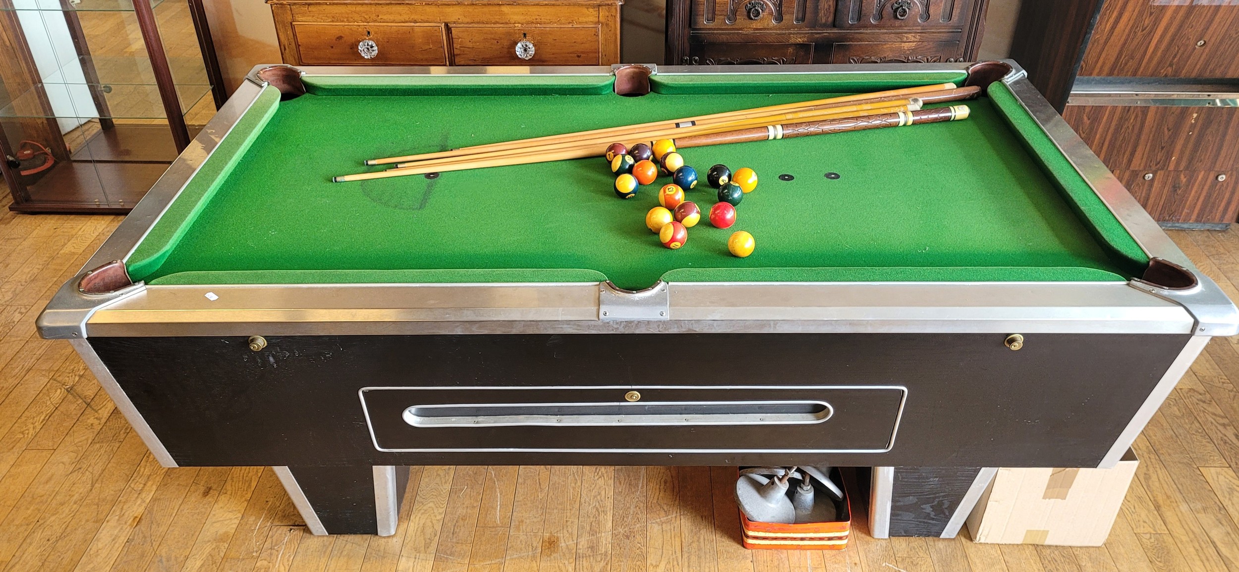 A coin operated pub pool table, slate bed with balls and five cues ...