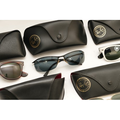 Five cased pairs of Ray-Ban designer sunglasses.