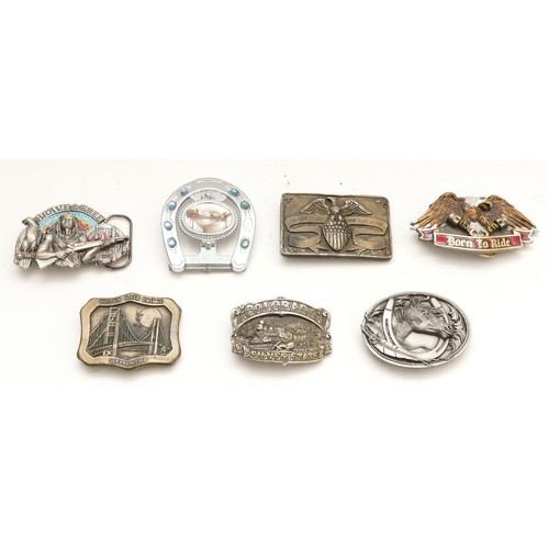 A collection of seven American cast metal belt buckles.
