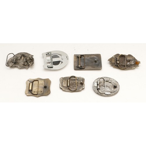 A collection of seven American cast metal belt buckles.