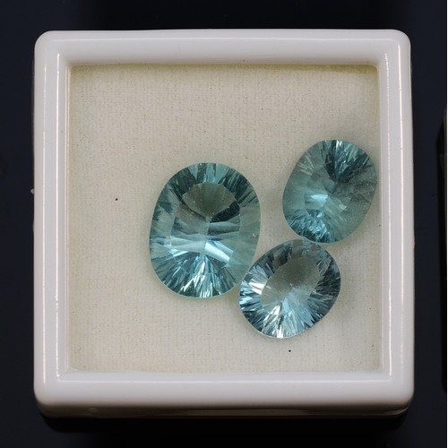 An oval cut blue gemstone, probably blue topaz, weighs 48.87ct on the Gemscale 125 Dendritics, 25mm