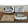 A pair of Hella 155 unused driving lamps with instructions