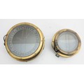 Two brass marine floating compasses.