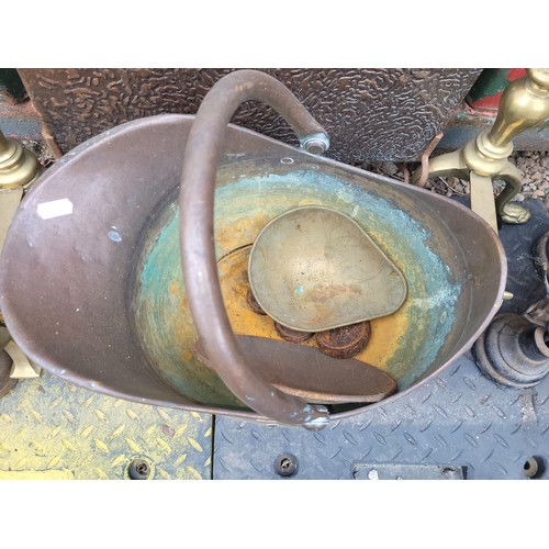 A group of metalwares, to include, brass fireside dogs, a copper coal ...
