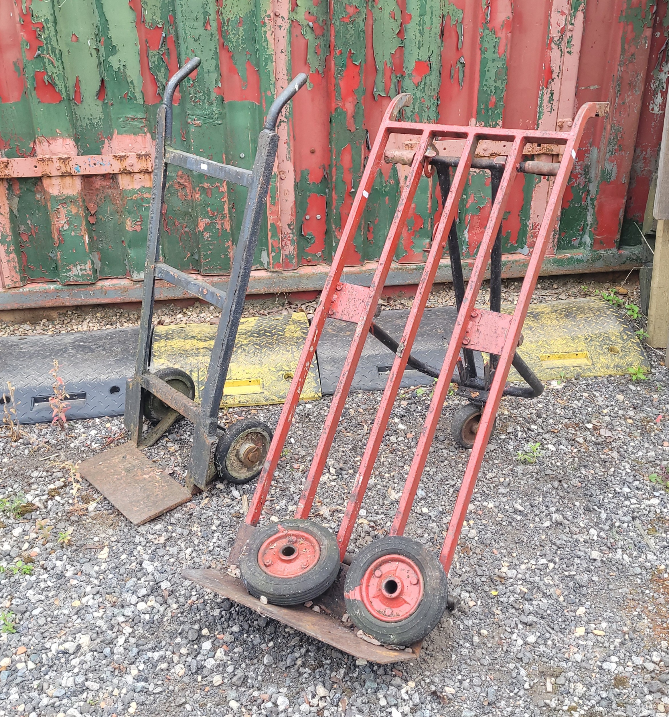 Two railway porter's trolleys, a two-wheeler sack barrow example, and a ...