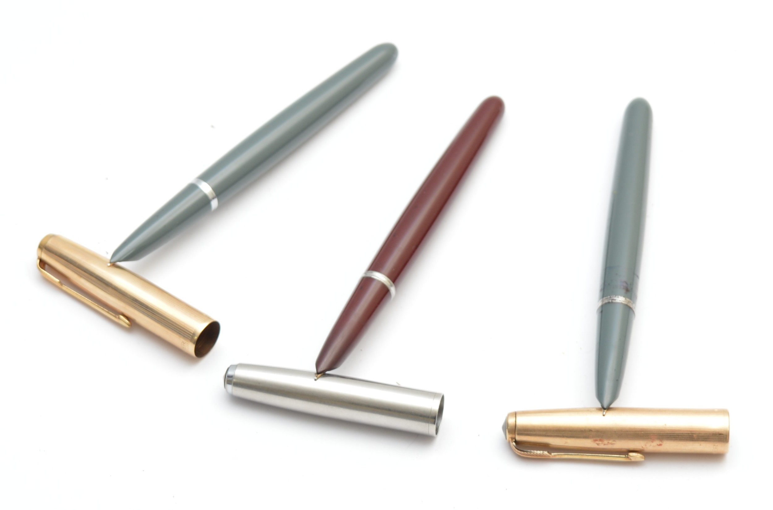 Three Parker 51 fountain pens, squeeze action filled.