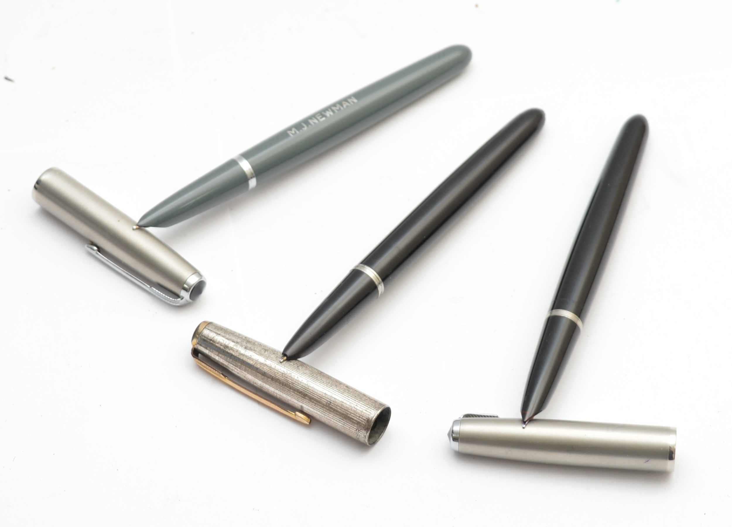 Three Parker 51 fountain pens, squeeze action filled, one being ...