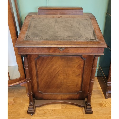 A late 20th century mahogany Davenport desk, hinged pen tray above a ...