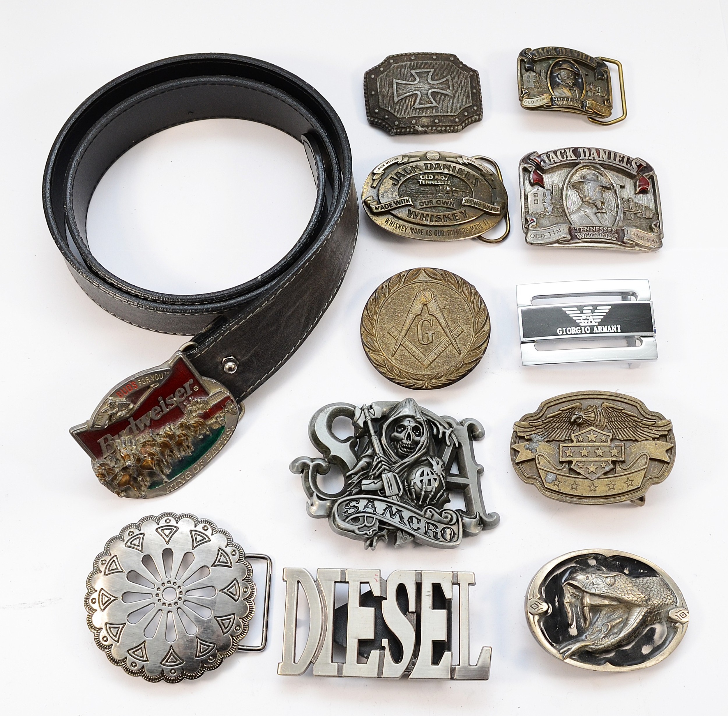 A collection of cast metal belt buckles, to include Jack Daniels, Iron ...