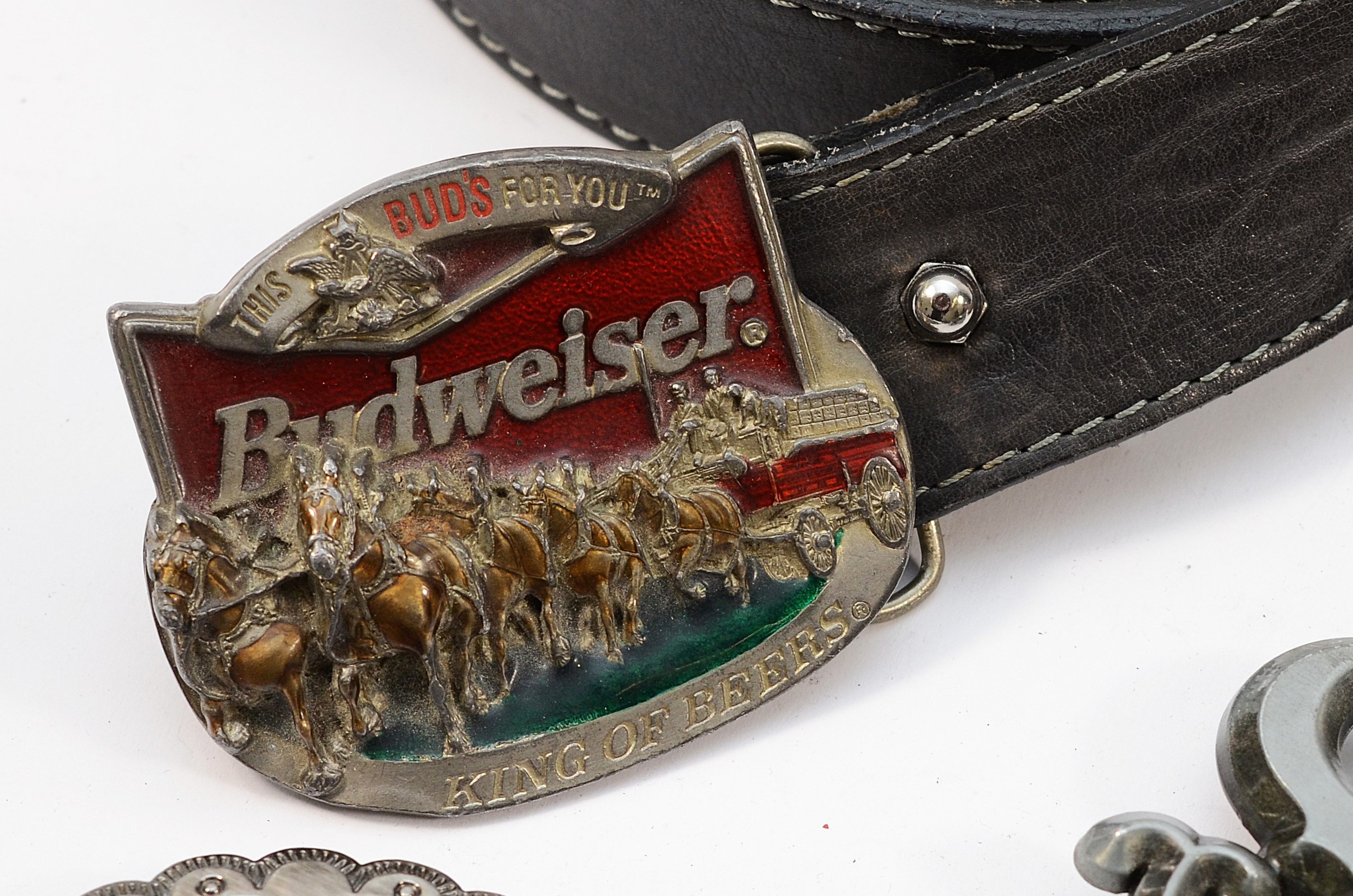 A collection of cast metal belt buckles, to include Jack Daniels, Iron ...