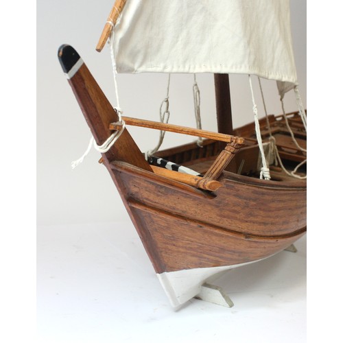 A scratch built wooden model of a Dhow, with cotton sail, 80cm.