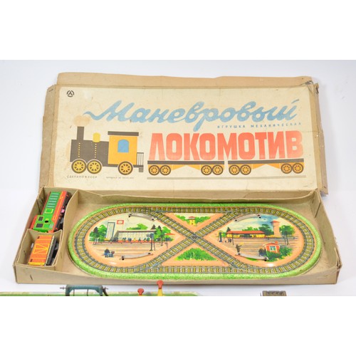 A boxed 1960s tinplate toy train set, having clockwork train and goods ...