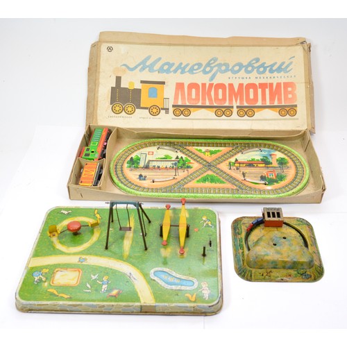 A boxed 1960s tinplate toy train set, having clockwork train and goods ...