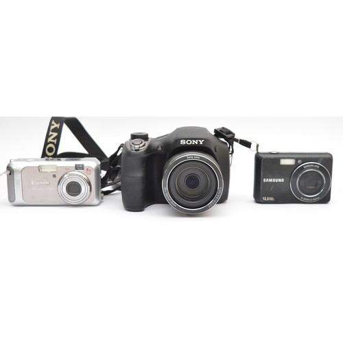 A Sony Cybershot DSC-H300 digital camera, together with a Canon ...