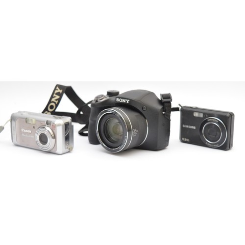 A Sony Cybershot DSC-H300 digital camera, together with a Canon ...