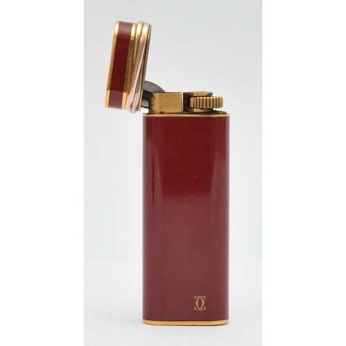 A must de Cartier Paris gas lighter with burgundy enamel casing and ...