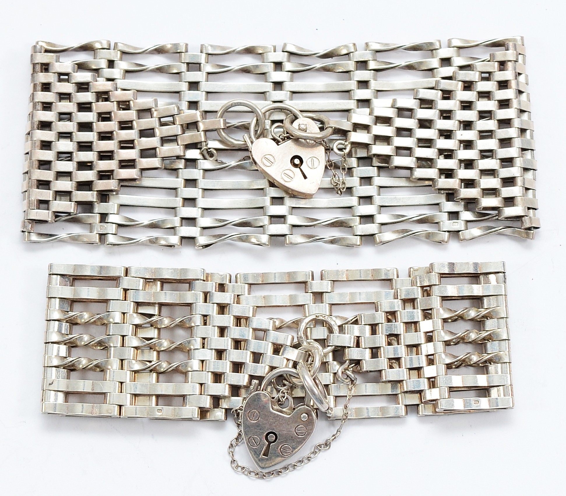 Two silver gate link bracelets with heart shaped padlock clasps, both ...
