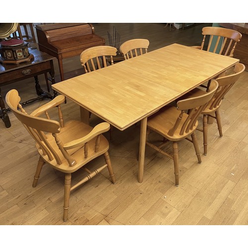 A modern pine extending dining table with a set of six (4+2 carvers ...