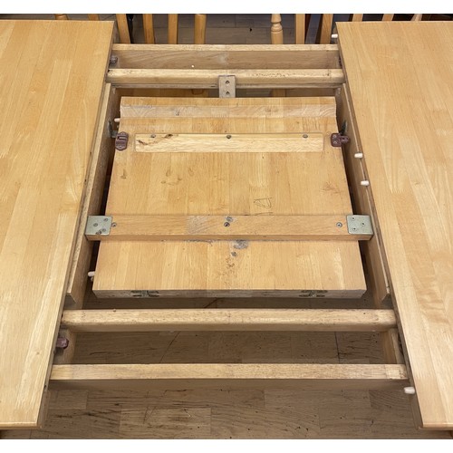 A modern pine extending dining table with a set of six (4+2 carvers ...
