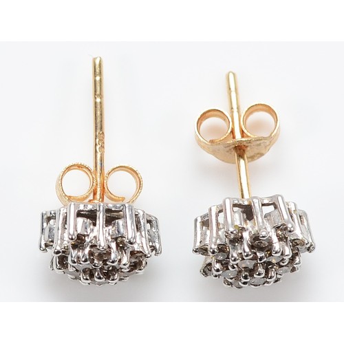 A pair of 9ct gold brilliant cut diamond cluster earrings with scroll ...