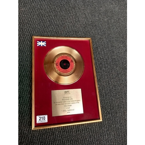 A BPI (British Phonographic Industry) framed and original gold single ...