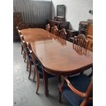 A large mahogany reproduction dining table with ten chairs including ...