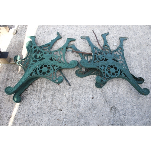 Two pairs of cast metal bench ends. Painted green. Max. H75cm