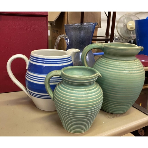 THREE LARGE POTTERY JUGS AND ONE LARGE BUBBLE JUG