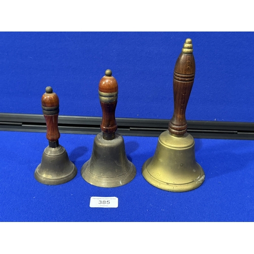 THREE GRADUATED BRASS BELLS WITH WOODEN HANDLES