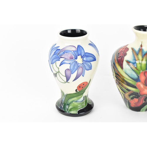 A collection of three small modern Moorcroft pottery vases, to include ...