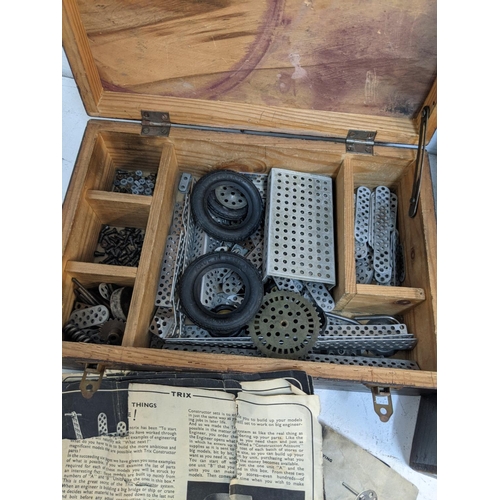 A box of Meccano, mainly in the bare metal, and a box of Trix ...