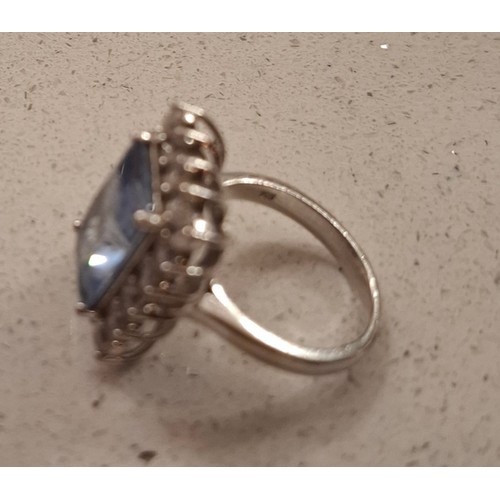 A Ciro large blue topaz ring surrounded by cubic zirconias set in a ...