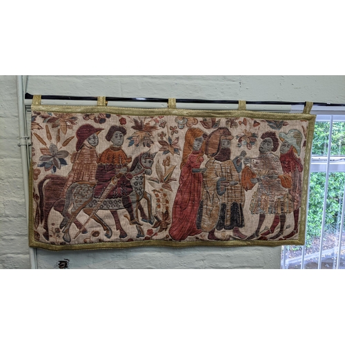A tapestry wall hanging depicting a traditional scene with a wrought ...