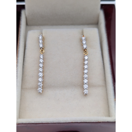 A pair of 18ct yellow and white gold diamond drop stud earrings set ...