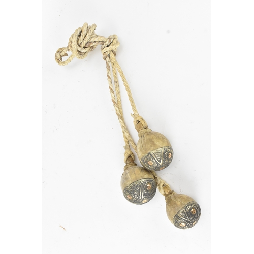A late 19th/early 20th century South American gaucho bolas, of three ...