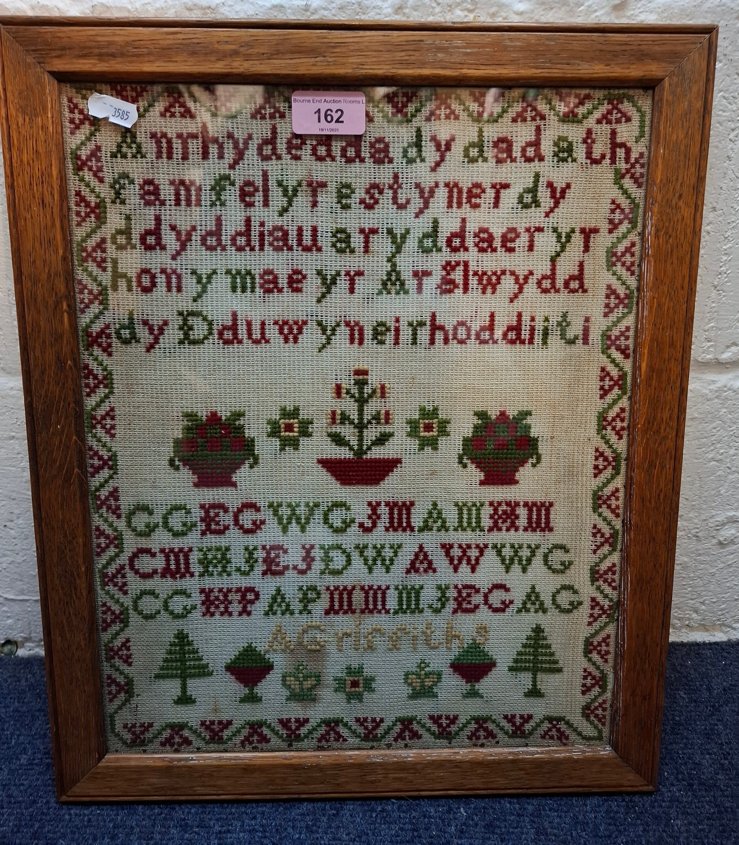 A mid 20th Century Welsh wool cross stitch sampler with religious verse ...