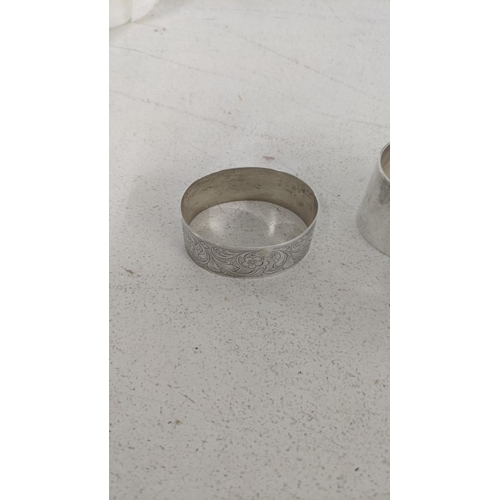 Four hallmarked silver napkin rings to include one hallmarked Sheffield ...